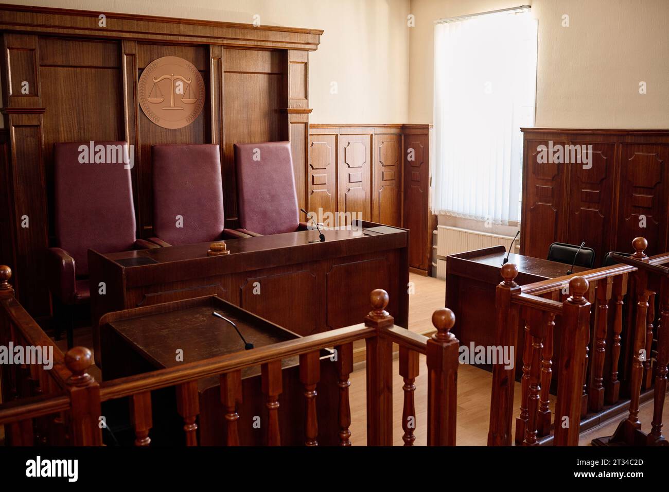 Part of spacious courtroom with wooden furniture and leather chairs for ...