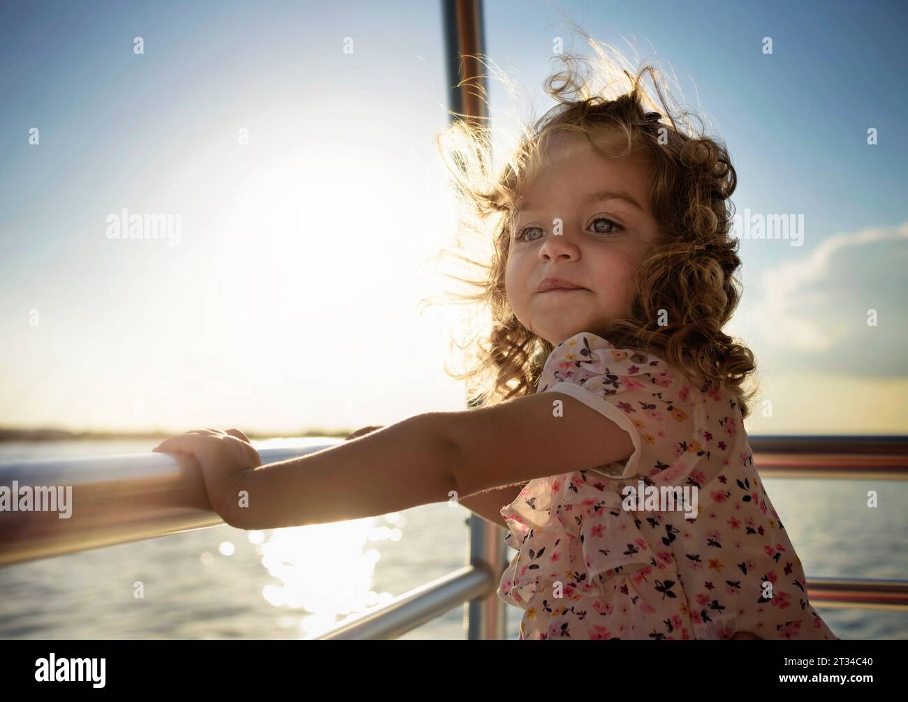 Little girl smiling on windy boat ride Stock Photo - Alamy