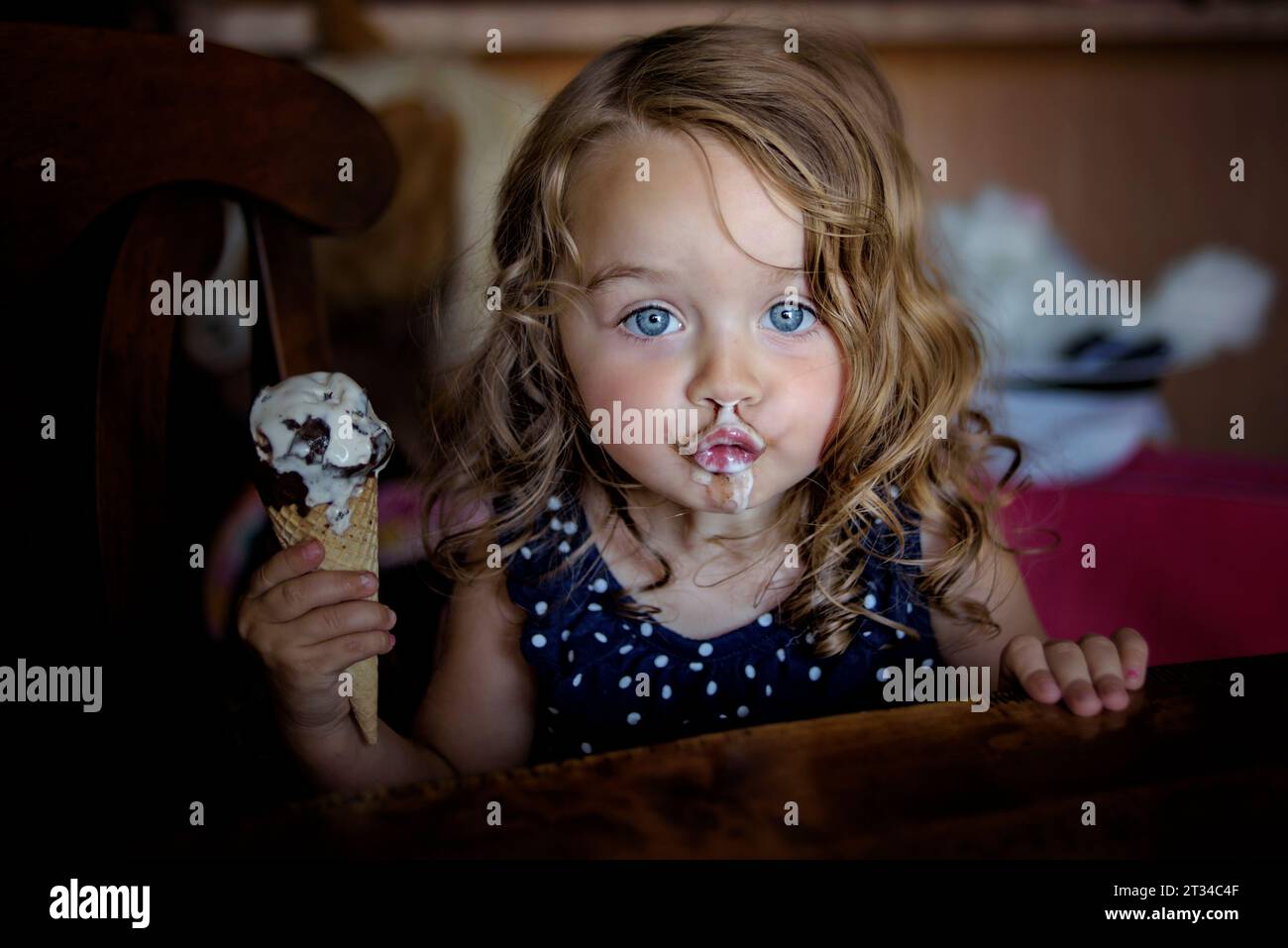 Beautiful little girl eating ice cream with a messy face Stock Photo ...