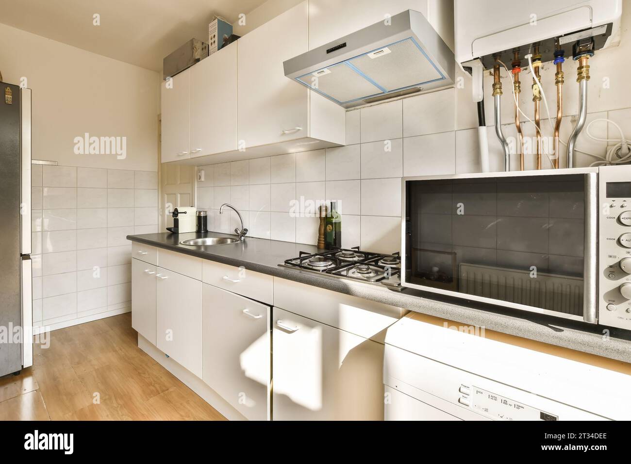 a kitchen with an oven, microwave and dishwasher in the photo is taken ...