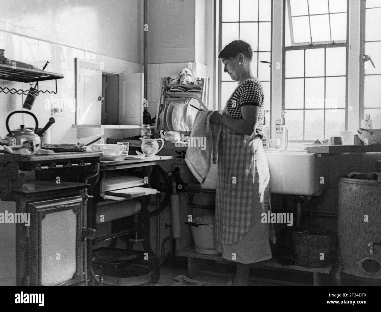 woman in 1930's kitchen in Britain Stock Photo - Alamy