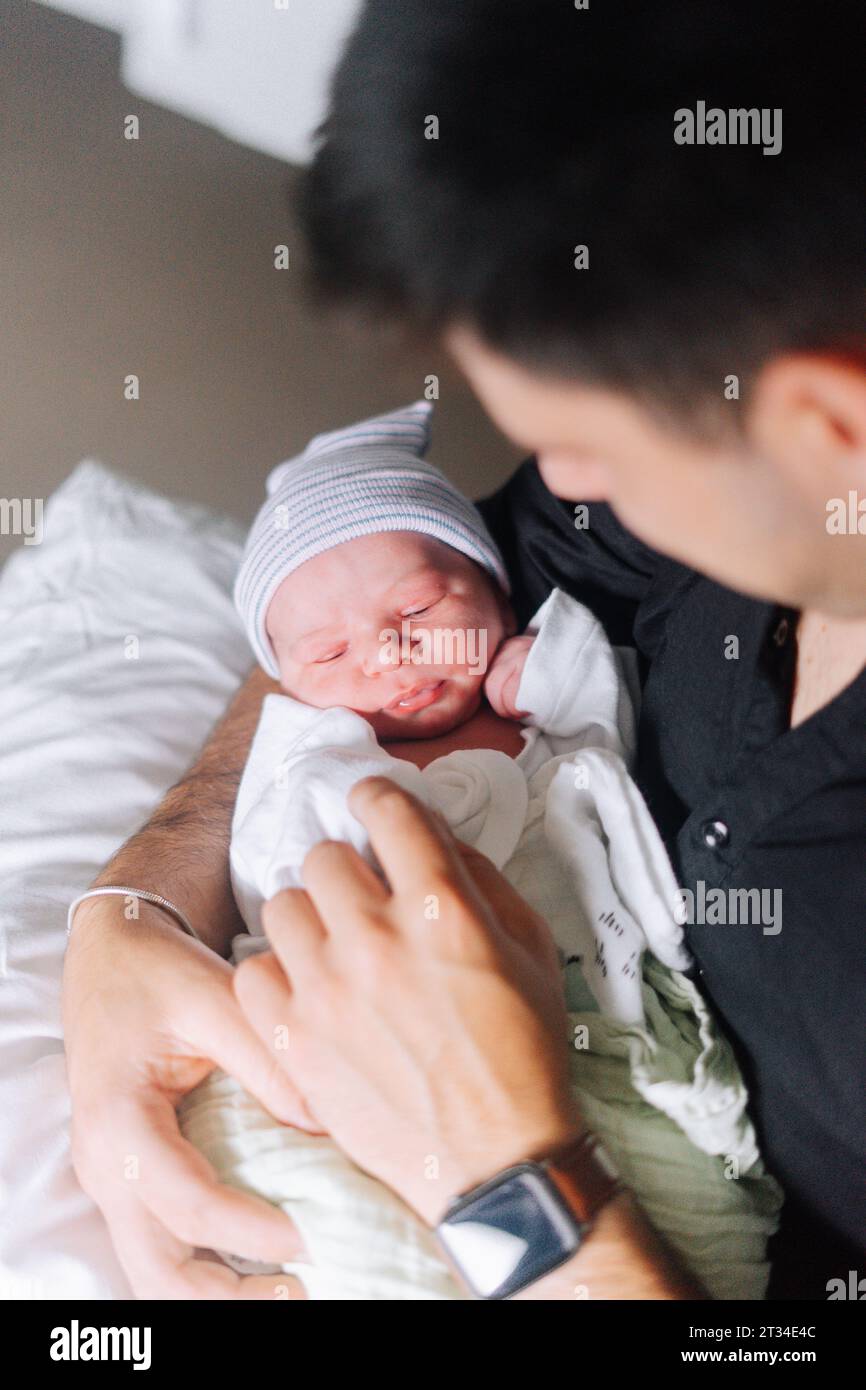 Portrait of an uncle with his one day old baby nephew Stock Photo - Alamy