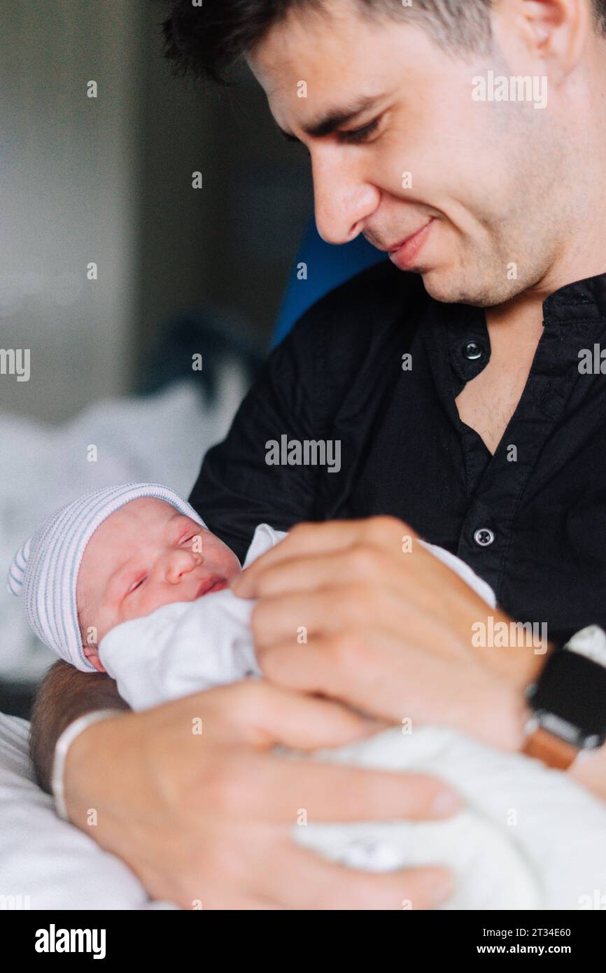 Portrait of an uncle with his one day old baby nephew Stock Photo - Alamy