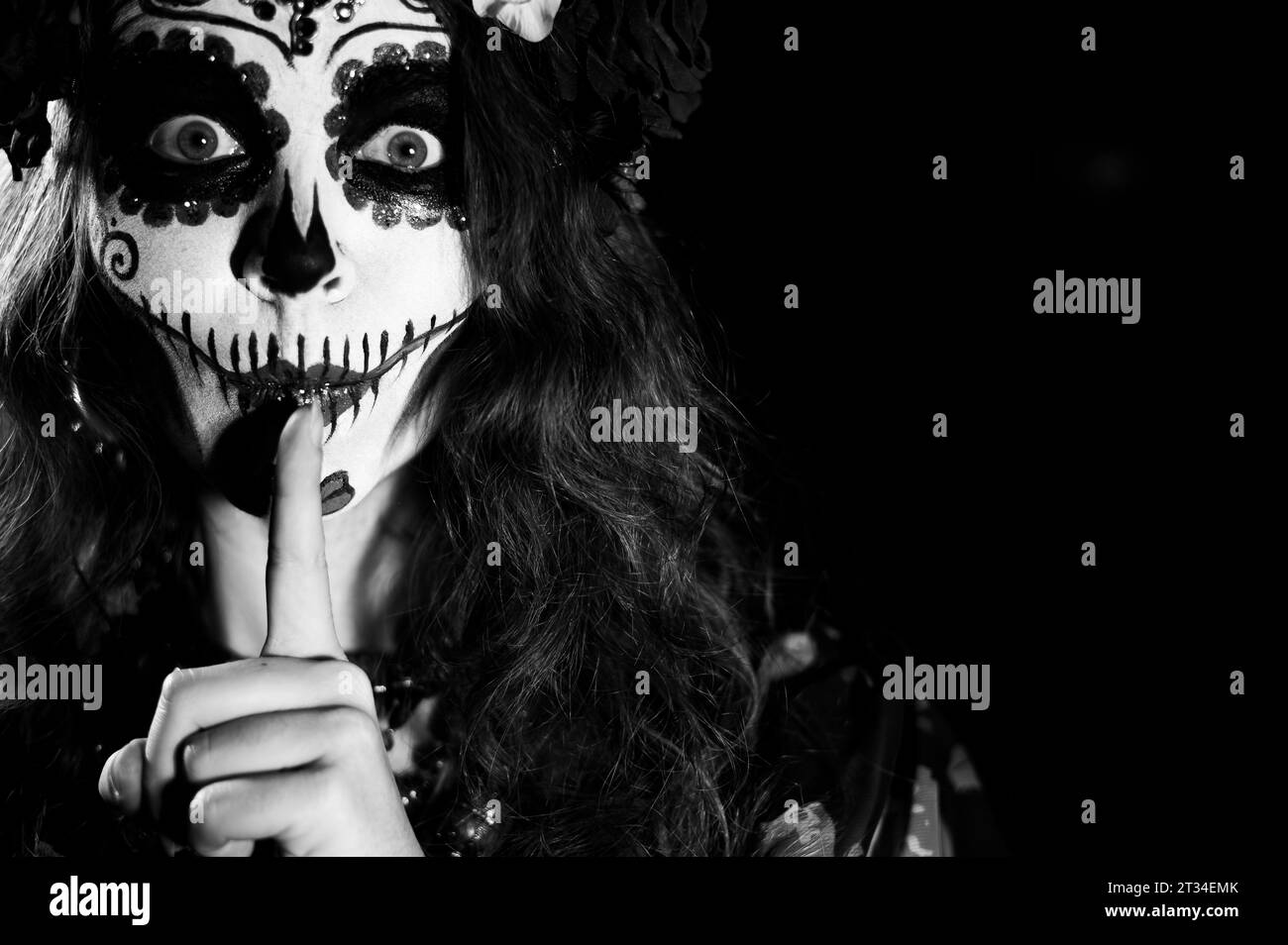 Woman in santa muerte makeup on a black background. Girl wearing ...