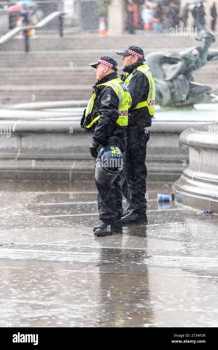 City of London Police officers caught in heavy rain at a Free Palestine ...