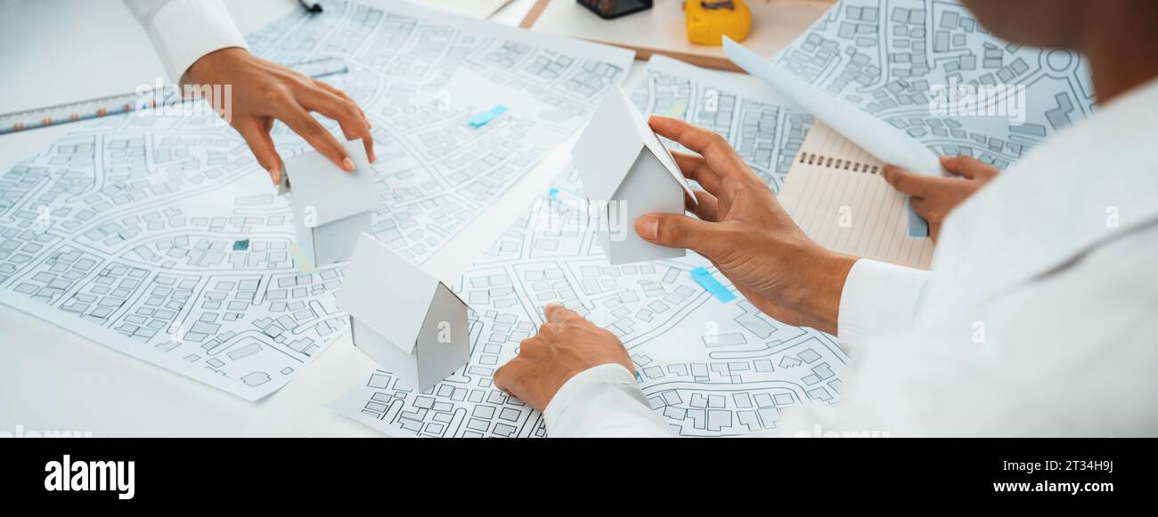 Worker, architect and engineer work on real estate construction project ...