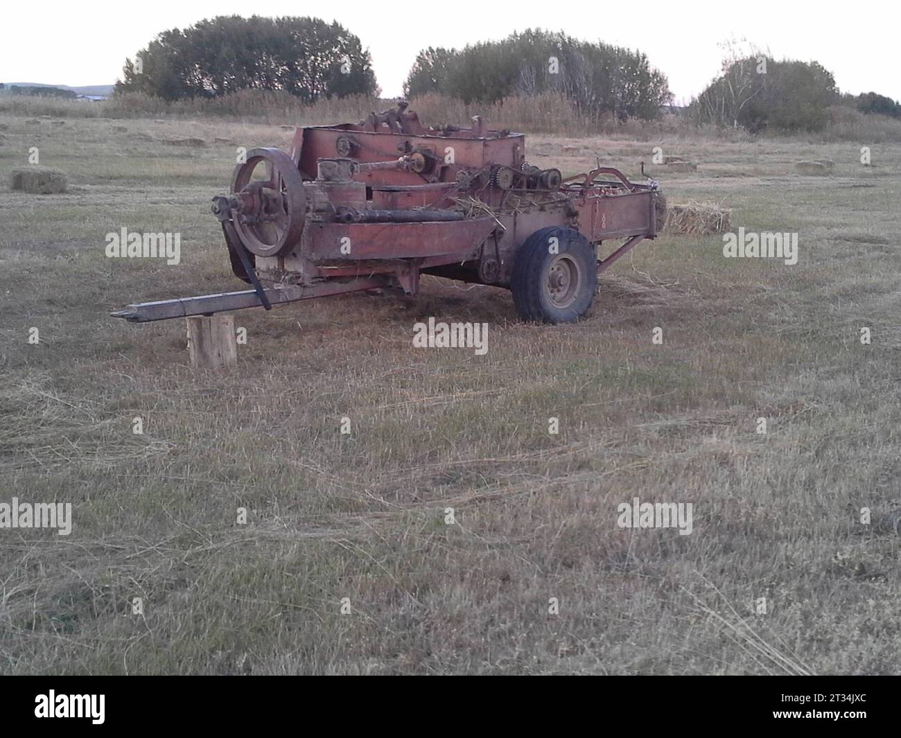An Old And Obsolete Agricultural Machinery Standing On A Farm Old And ...