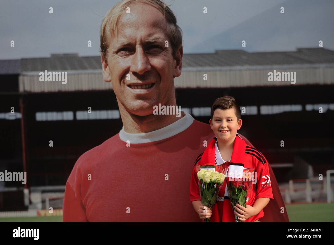A young fan pays his respects to the late Sir Bobby Charlton outside of ...