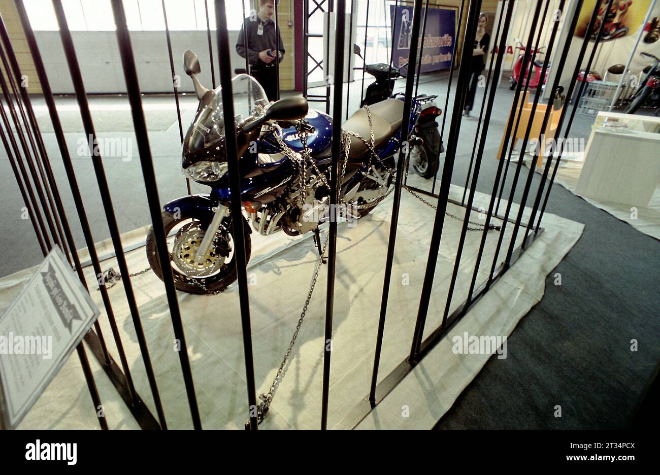 An expensive motorcycle from a famous brand in a cage at an exhibition ...