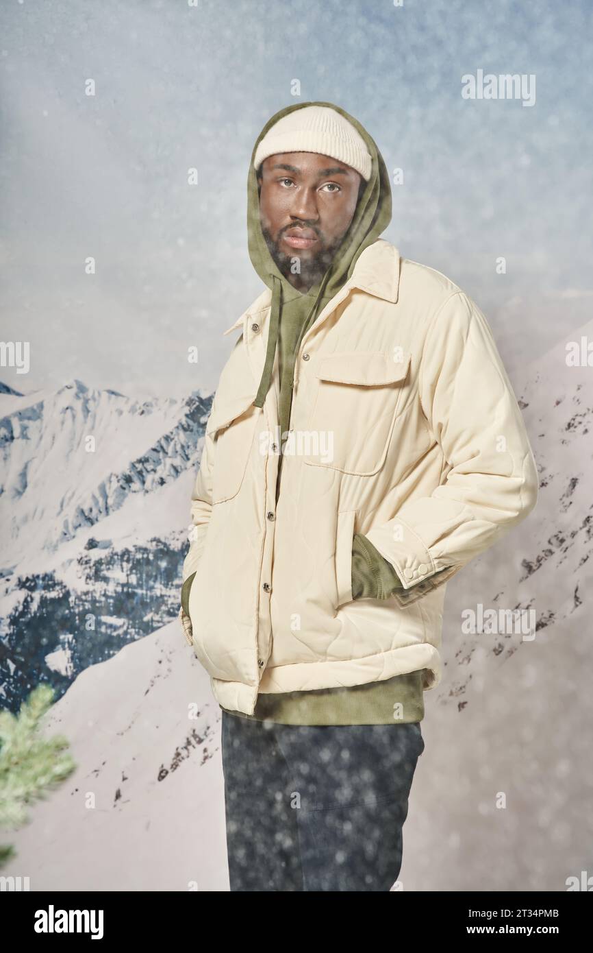 stylish african american man posing with hands in pockets standing ...