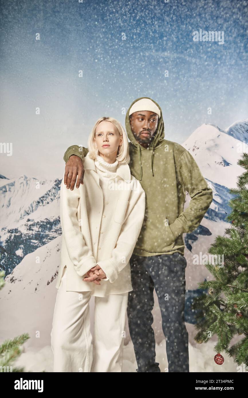 good looking man in stylish jacket putting his arm on his girlfriend ...