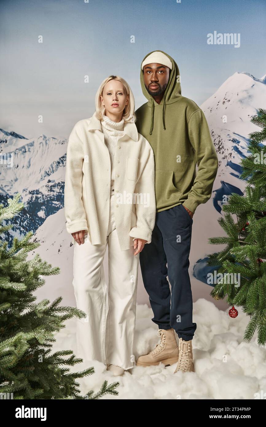 beautiful multicultural couple standing side by side with mountain ...