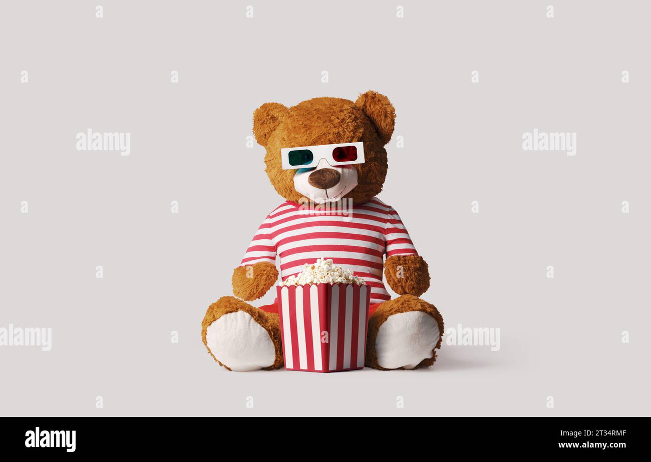 Cute teddy bear watching movies and eating popcorn Stock Photo - Alamy