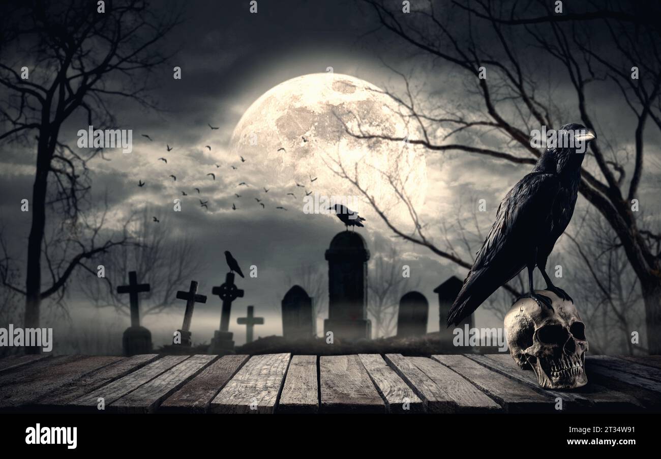 Creepy old cemetery at night with spooky crow standing on a human skull ...