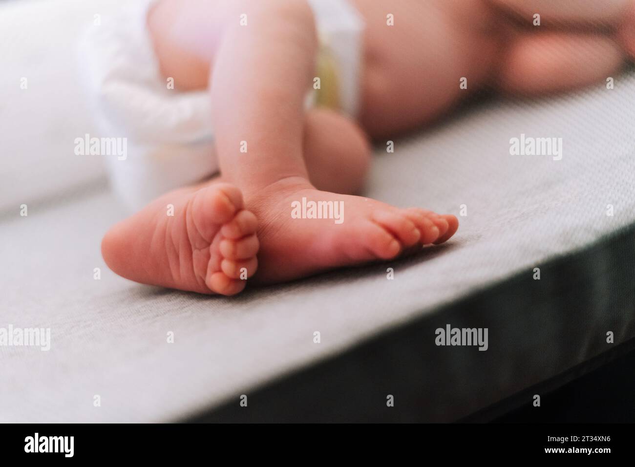 Detail of the feet of a one week old newborn baby sleeping on a baby ...