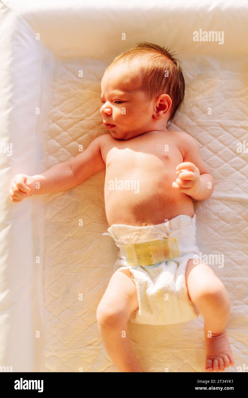 Portrait of a one week old newborn baby on a baby changer Stock Photo ...