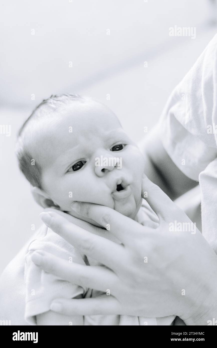 Portrait of a one week old newborn baby making funny faces Stock Photo ...