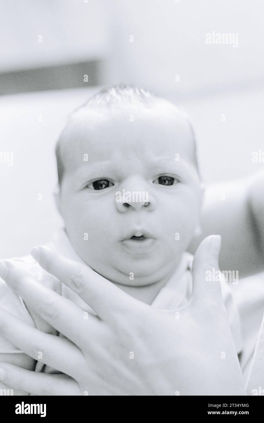 Portrait of a one week old newborn baby making funny faces Stock Photo ...