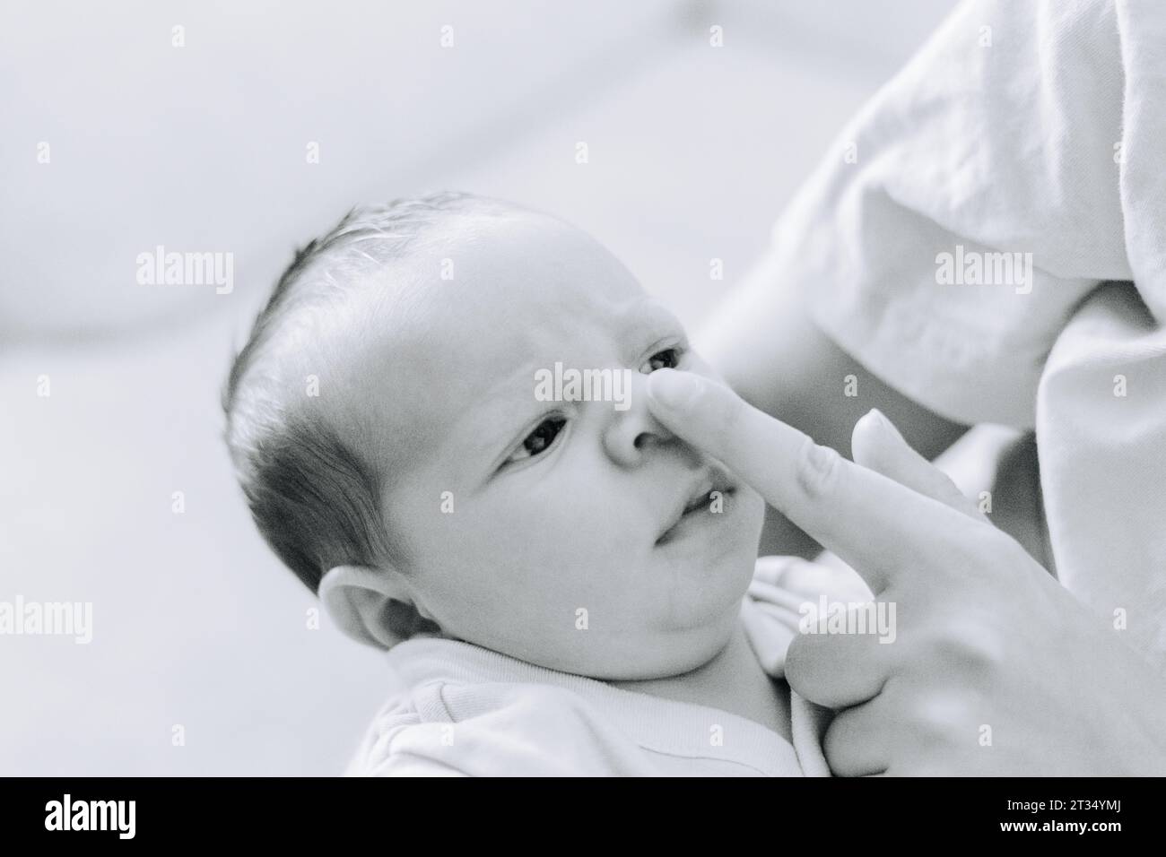 Portrait of a one week old newborn baby making funny faces Stock Photo ...