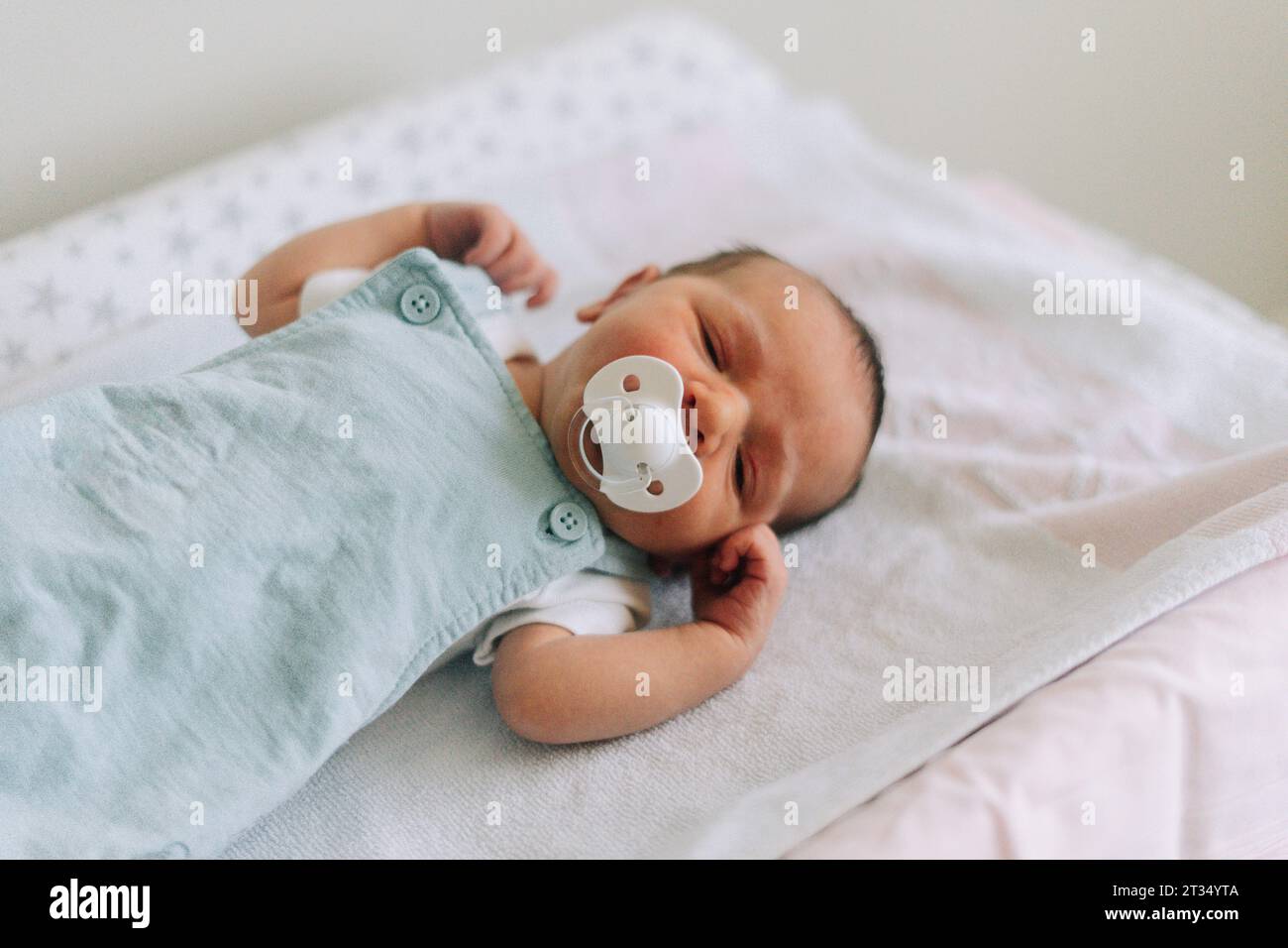 Portrait of a one day old newborn on a baby changer Stock Photo - Alamy