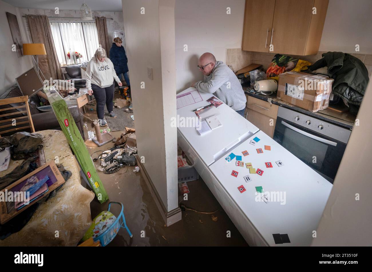 David Pickering and Lynsey France (left) inspect flood damage in their ...