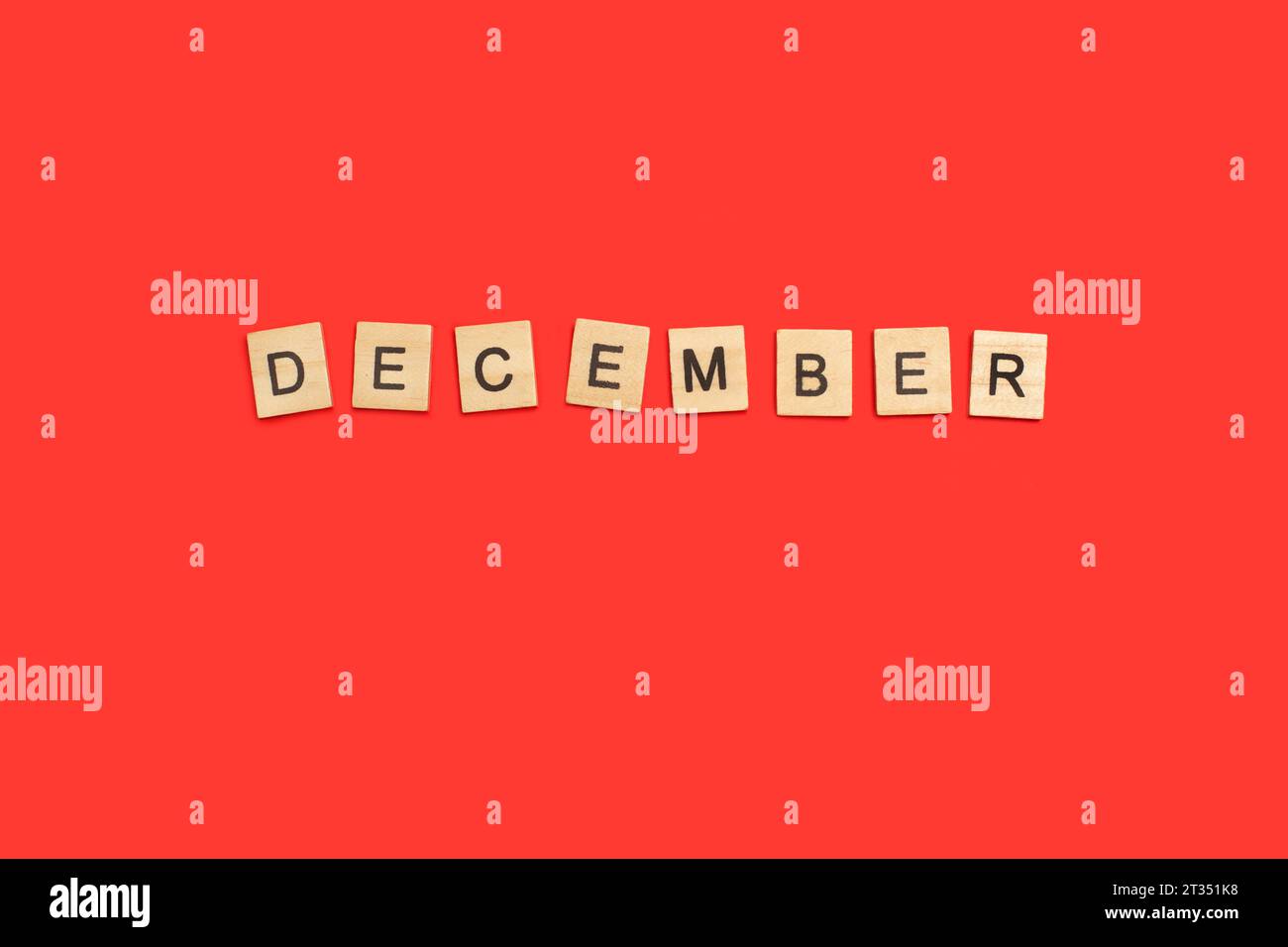 December word made with wooden letter blocks on an red background Stock ...
