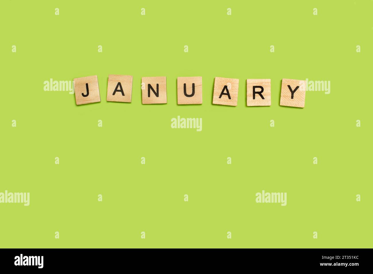 January word made with wooden letter blocks on a green background Stock ...