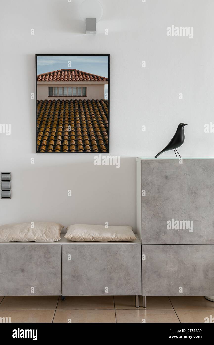 Bench with pillows and storage under picture in entryway Stock Photo ...