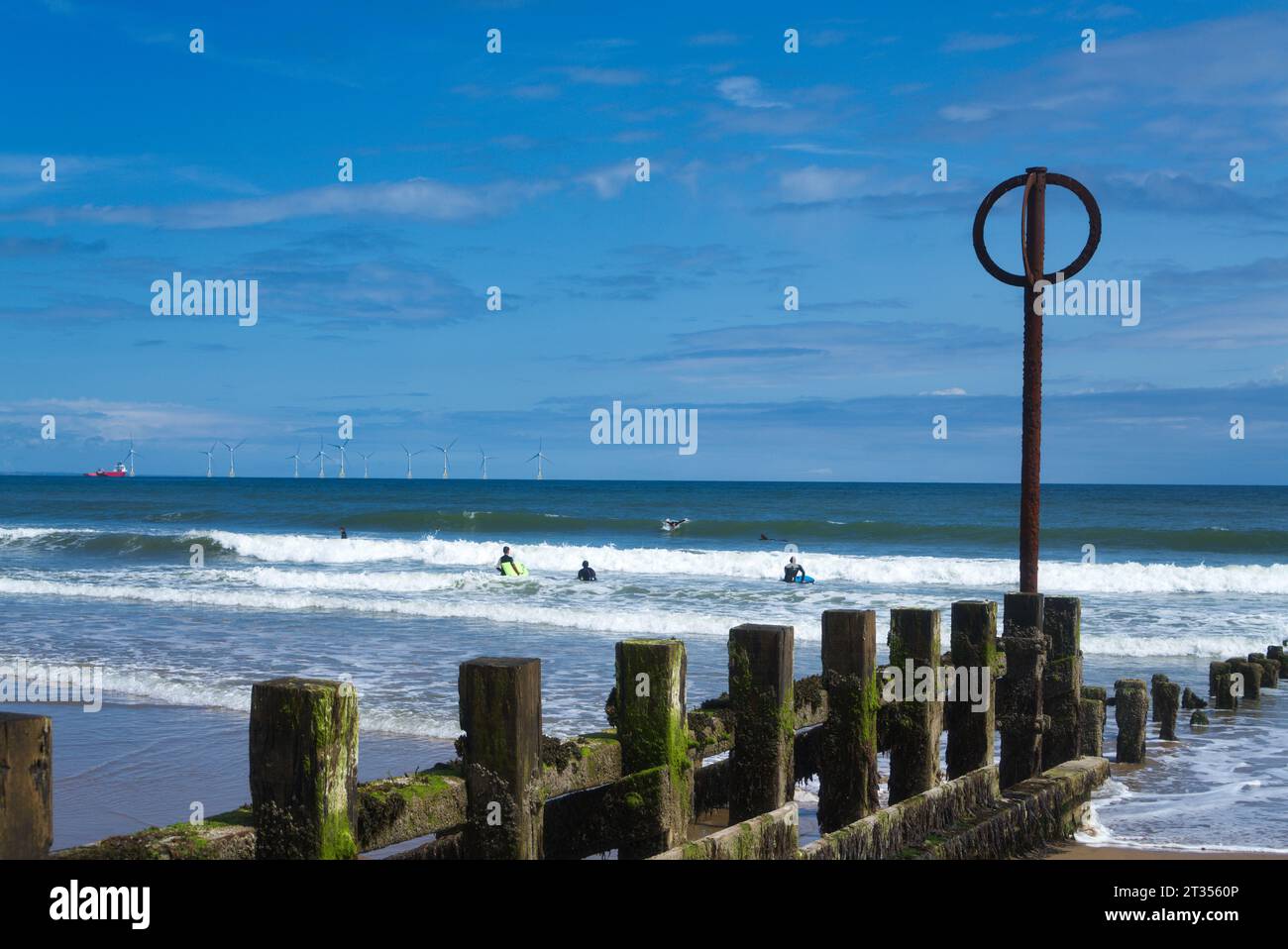 Aberdeen beach looking out to north sea, wind farm, promenade. Surfers ...