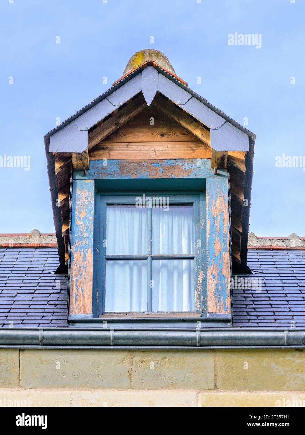 Roof gable window in need of repainting - central France Stock Photo ...