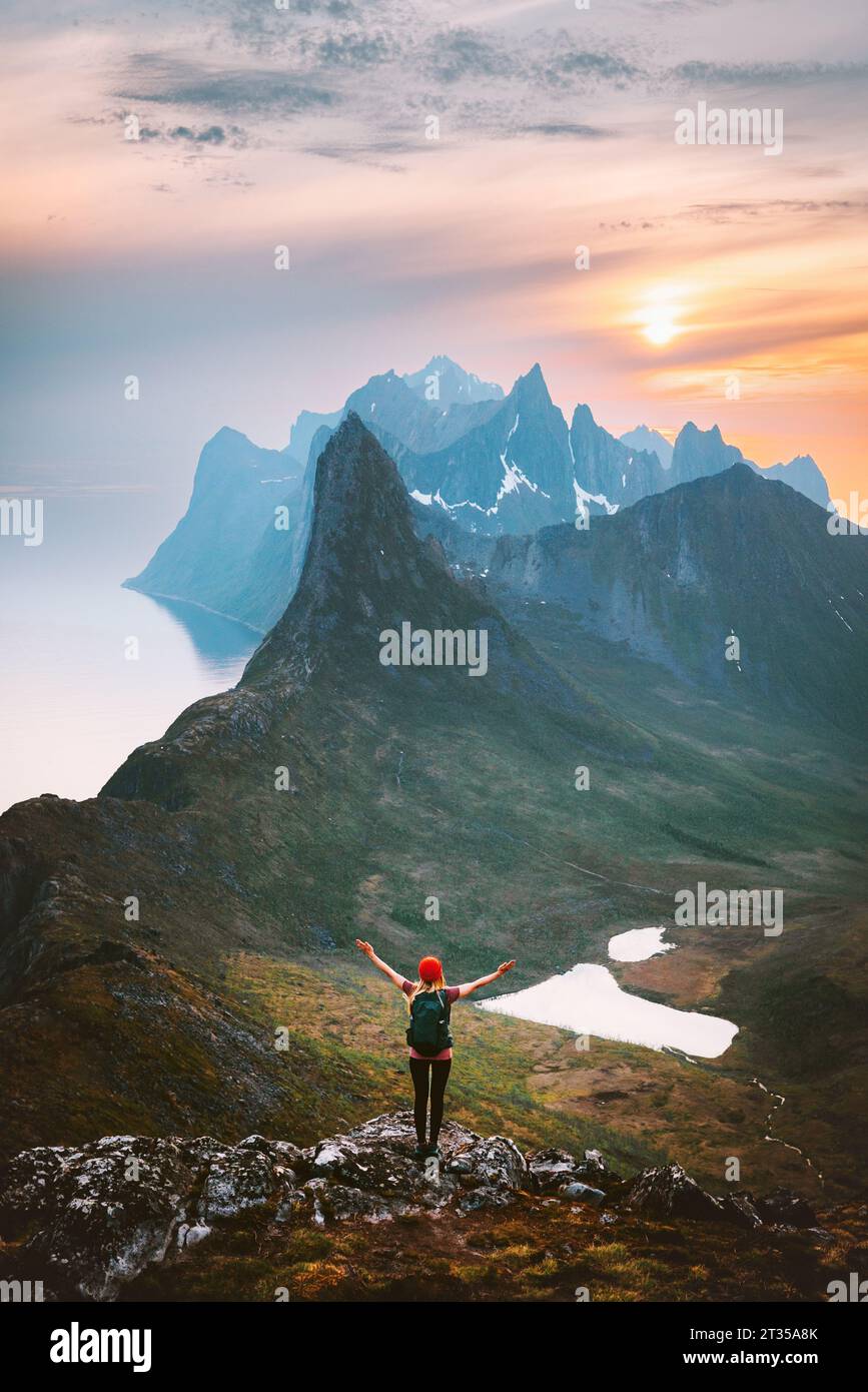 Norway travel outdoor activity traveler raised arms alone hiking in ...