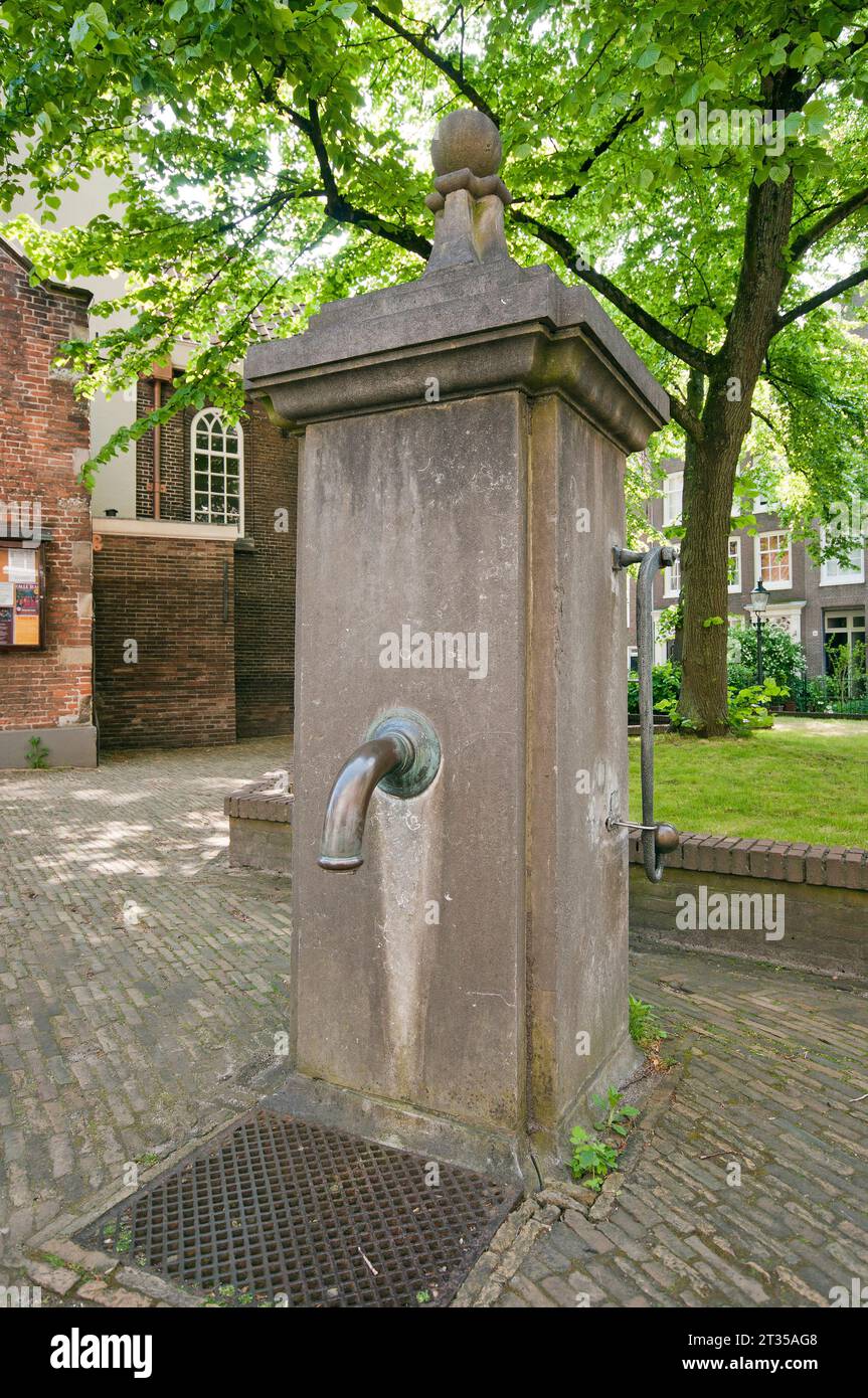Old hand water pump in the courtyard of the Begijnhof, Amsterdam ...