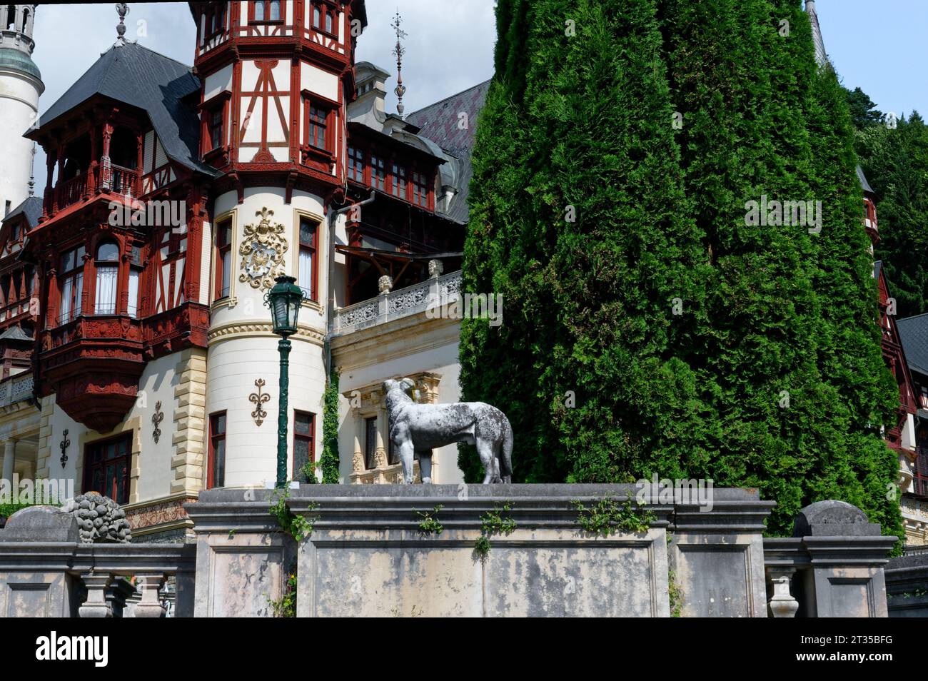 Beauty of peles castle's exterior on a sun-drenched day, dog statue ...