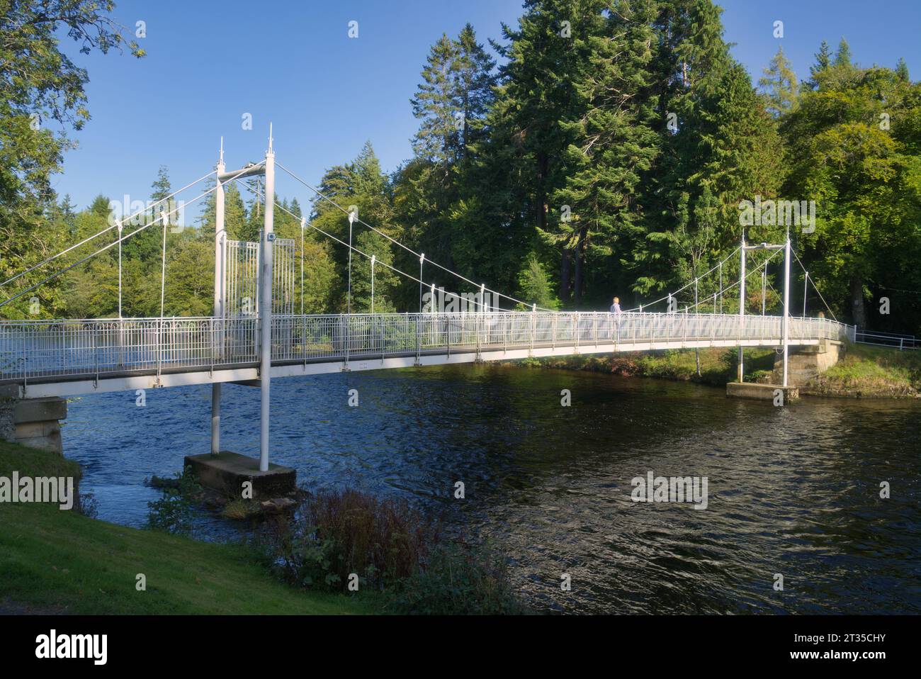 River Ness near Centre of Inverness. Woman standing on white chain link ...