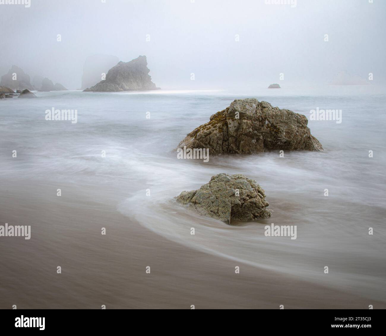 Boulders and sea stacks on a foggy day at Harris Beach State Park in ...