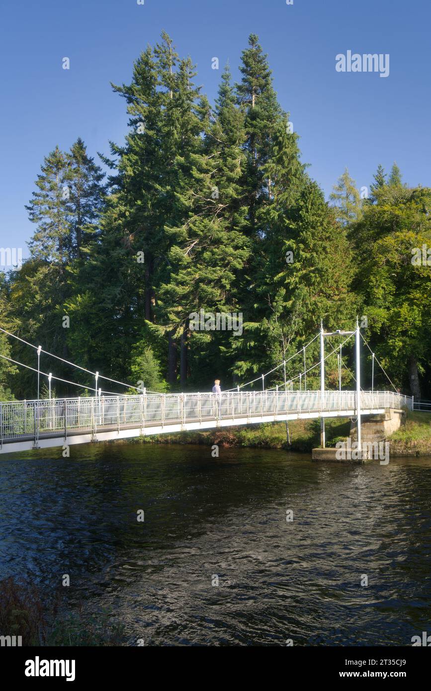 River Ness near Centre of Inverness. Woman crossing white chain link ...