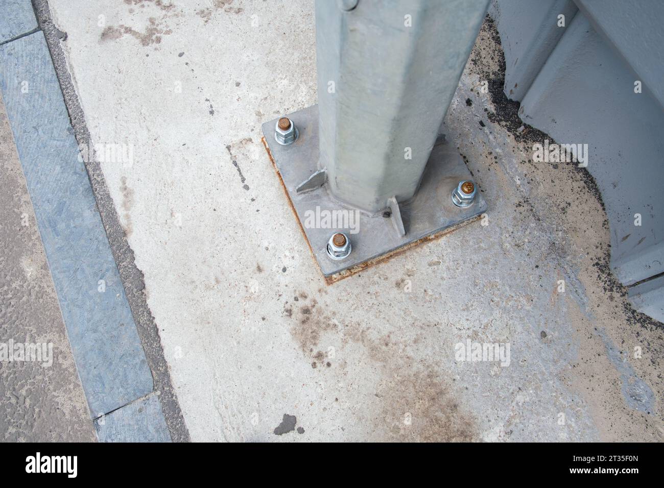 The metal support is attached to the concrete base with anchor bolts ...