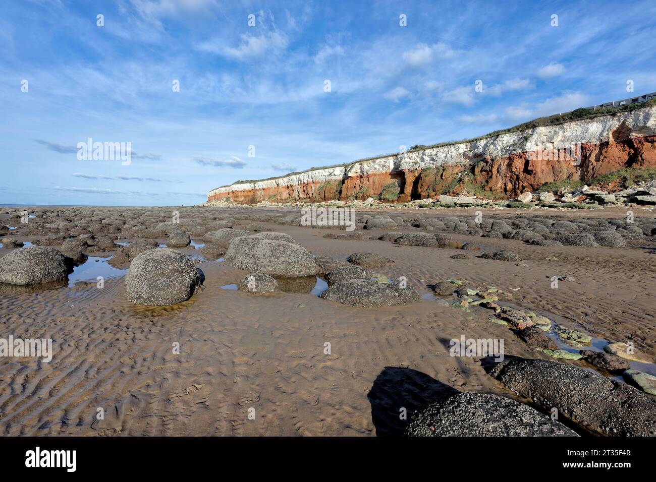 Red and white striped cliffs (carstone and chalk ) at hunstanton ...