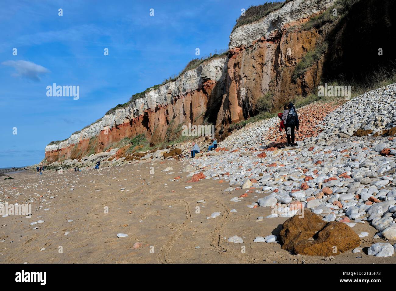 Red and white striped cliffs (carstone and chalk ) at hunstanton ...