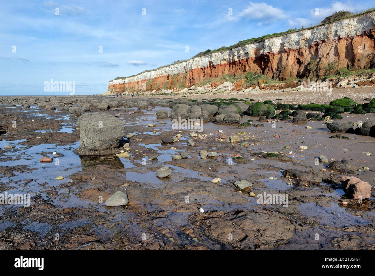 Red and white striped cliffs (carstone and chalk ) at hunstanton ...