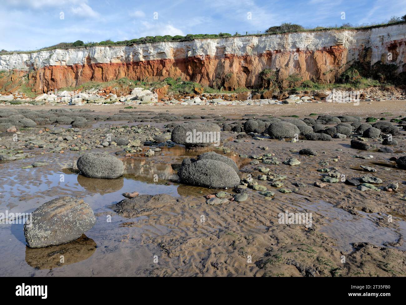 Red and white striped cliffs (carstone and chalk ) at hunstanton ...