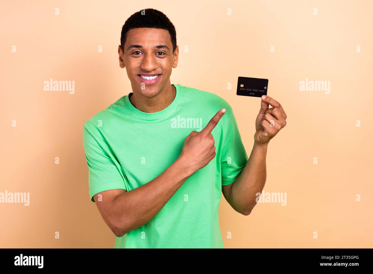 Photo portrait of handsome young guy hold point credit card dressed ...