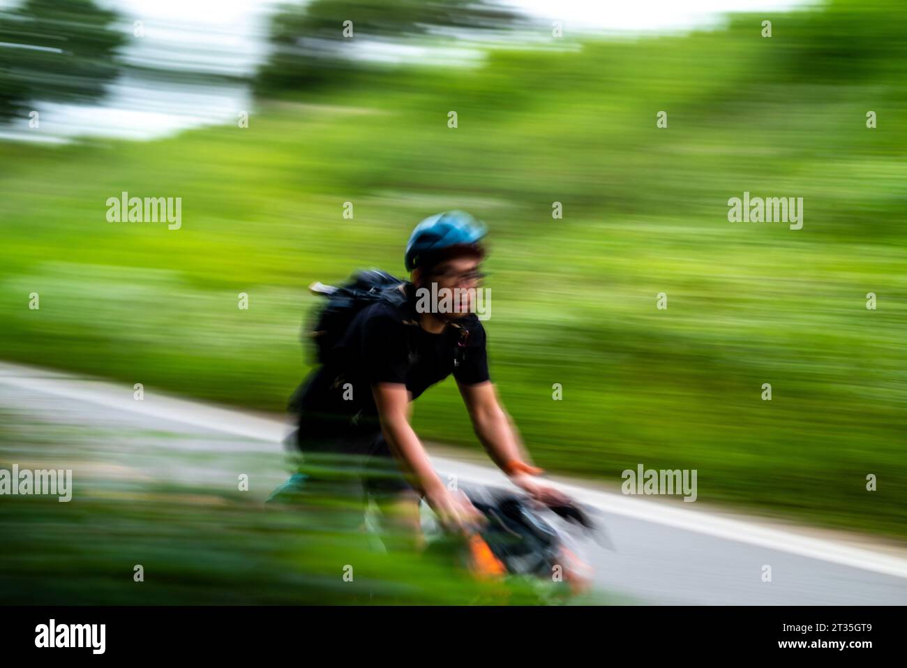 Intentional camera movement blur of speeding cyclist on Hangang Han ...