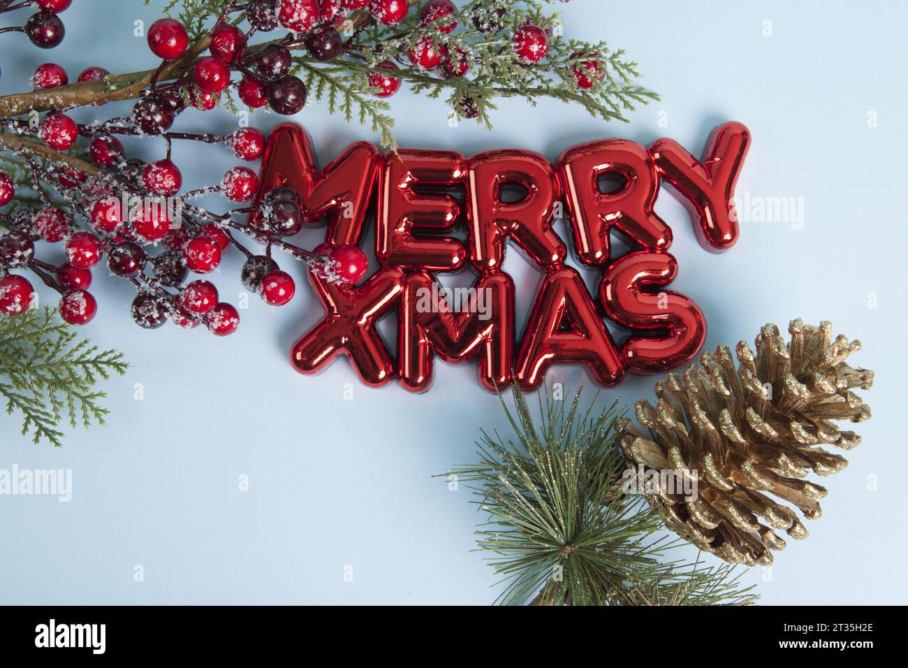 A glossy red plastic Christmas ornament featuring a text saying merry ...