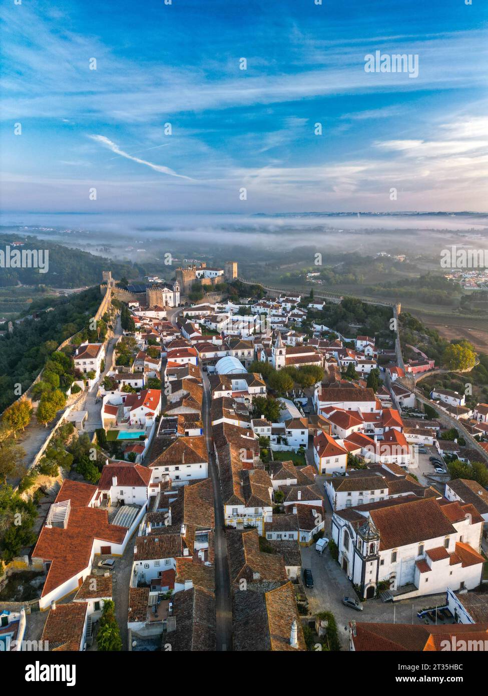 An idyllic Portuguese townscape featuring an array of traditional white ...