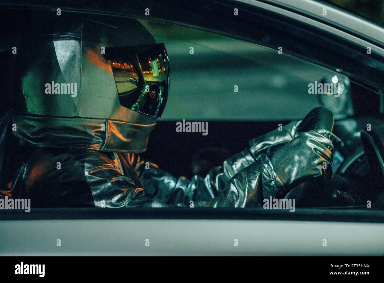 Spaceman driving car at night Stock Photo - Alamy