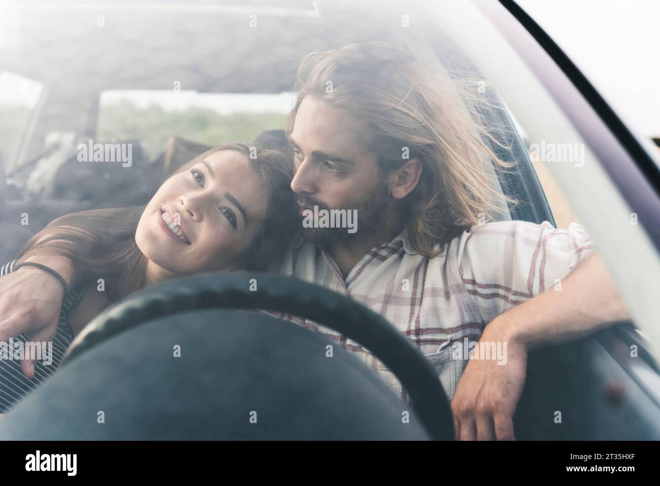 Affectionate young couple in a car Stock Photo - Alamy