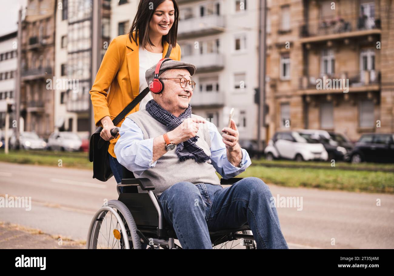 Old man pushing wheelchair hi-res stock photography and images - Alamy