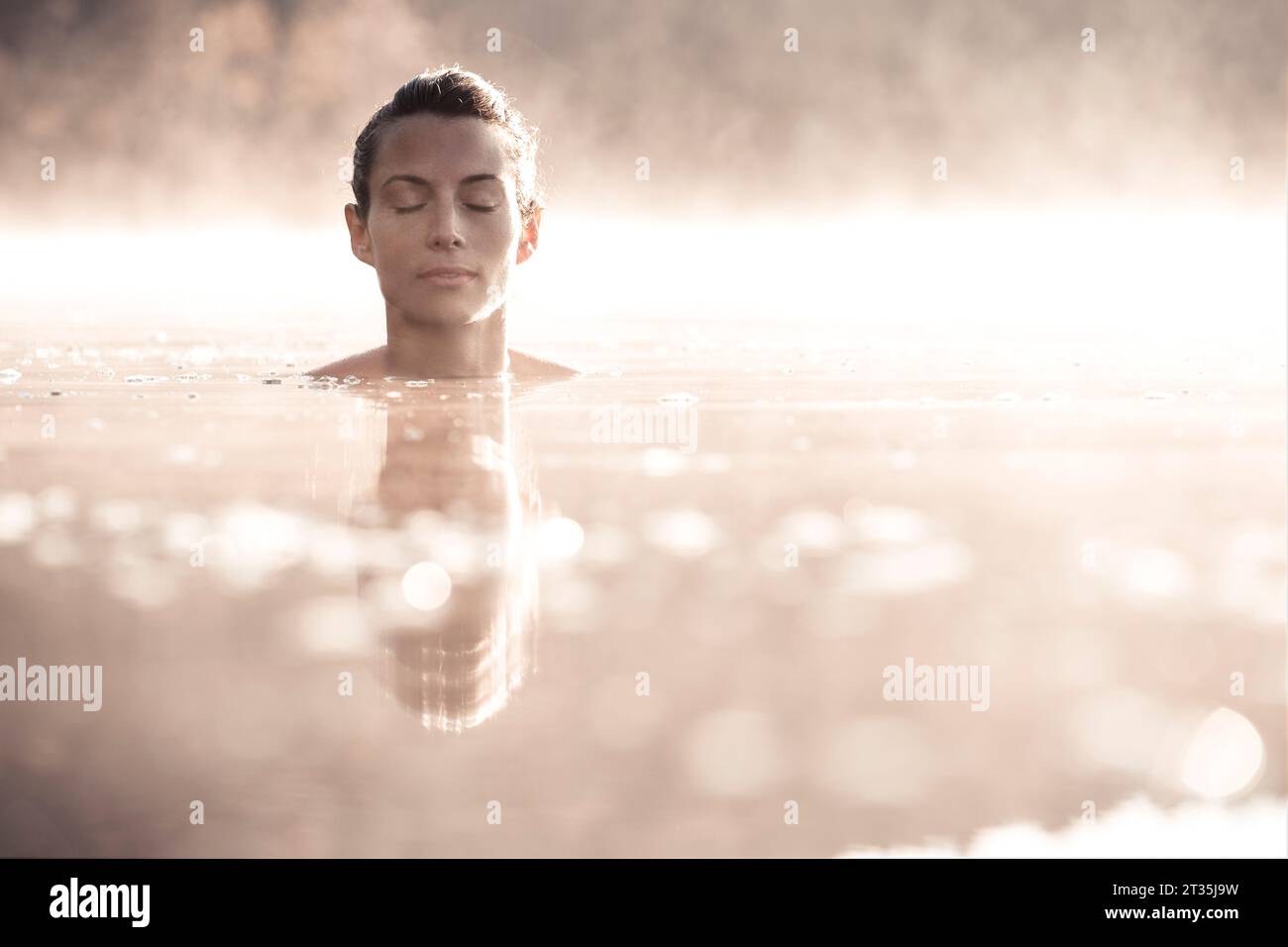 Woman bathing in a lake at morning mist Stock Photo - Alamy