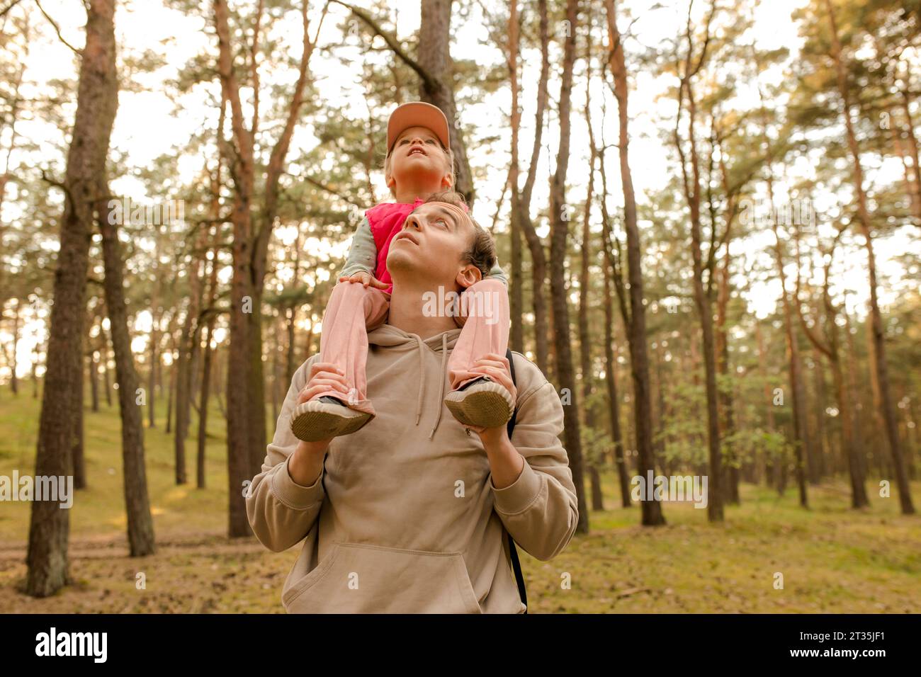 Father exploring forest with daughter sitting on shoulder Stock Photo ...